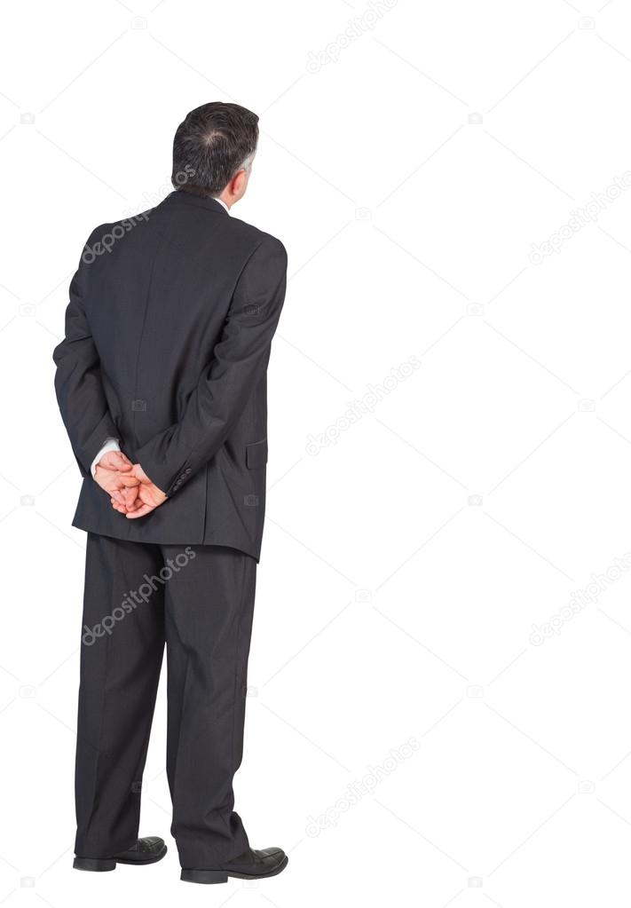 Mature businessman with hands behind back Stock Photo by ...