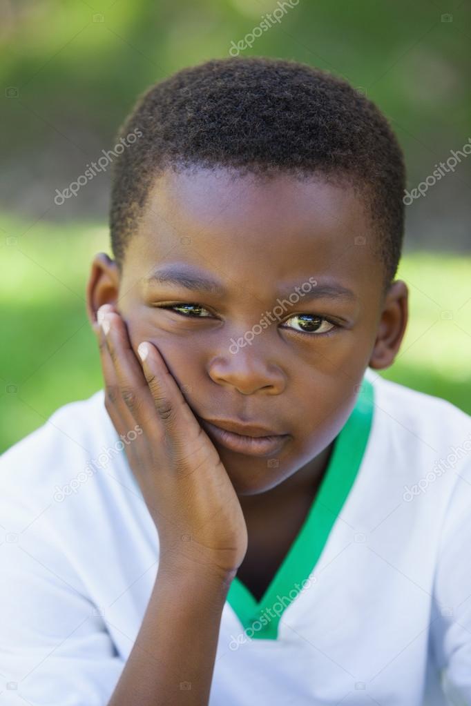 Cute boy pouting in the park Stock Photo by ©Wavebreakmedia 46791953 Cute boy pouting in the park Stock Photo by ©Wavebreakmedia 46791953