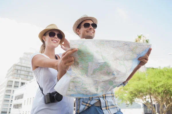 Tourist couple using the map - Stock Image - Everypixel