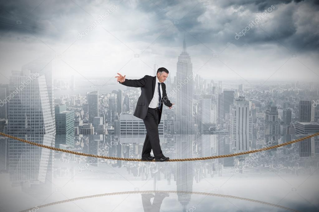 Businessman doing balancing act on tightrope — Stock Photo ...