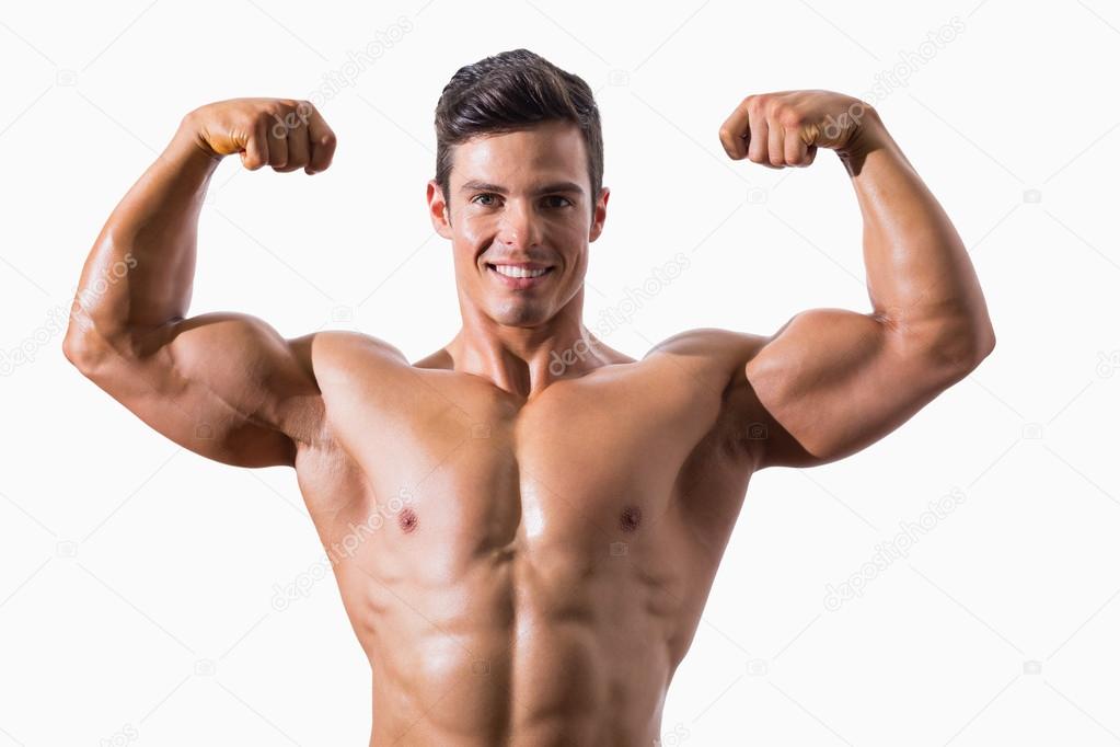 Portrait Of A Muscular Young Man Flexing Muscles Stock