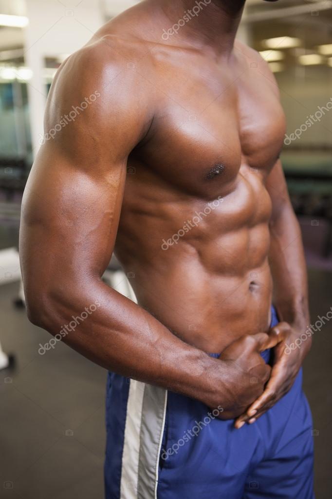 Mid section of a shirtless muscular man in gym Stock Photo by ...