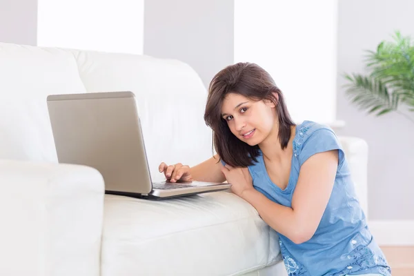 Young woman relaxing on the sofa with her laptop — Stock Photo ...