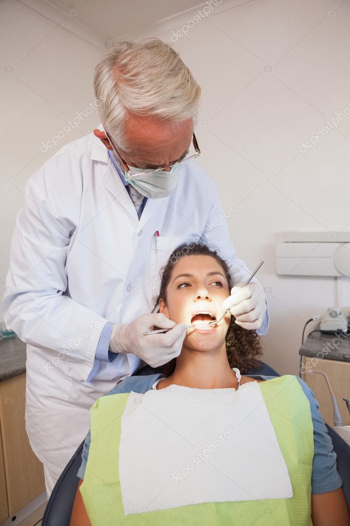 Dentist examining a patients teeth Stock Photo by ©Wavebreakmedia 51593149