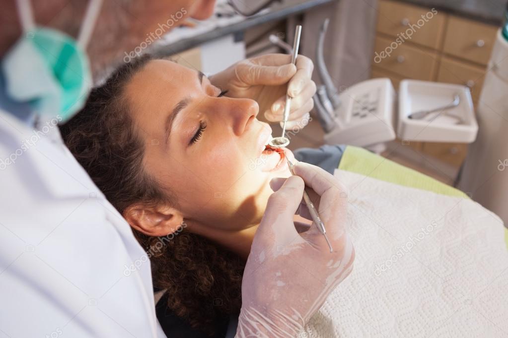 Dentist examining a patients teeth — Stock Photo © Wavebreakmedia #51599711