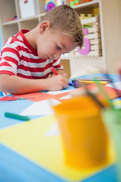 Cute little boy drawing at desk Stock Photo by ©Wavebreakmedia 51593153