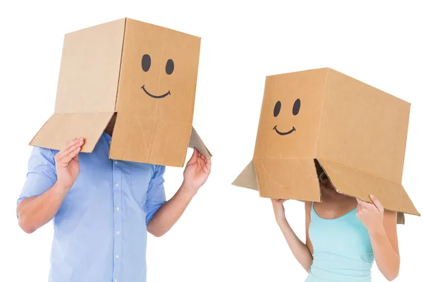 Couple wearing smiley face boxes on their heads — Stock Photo ...