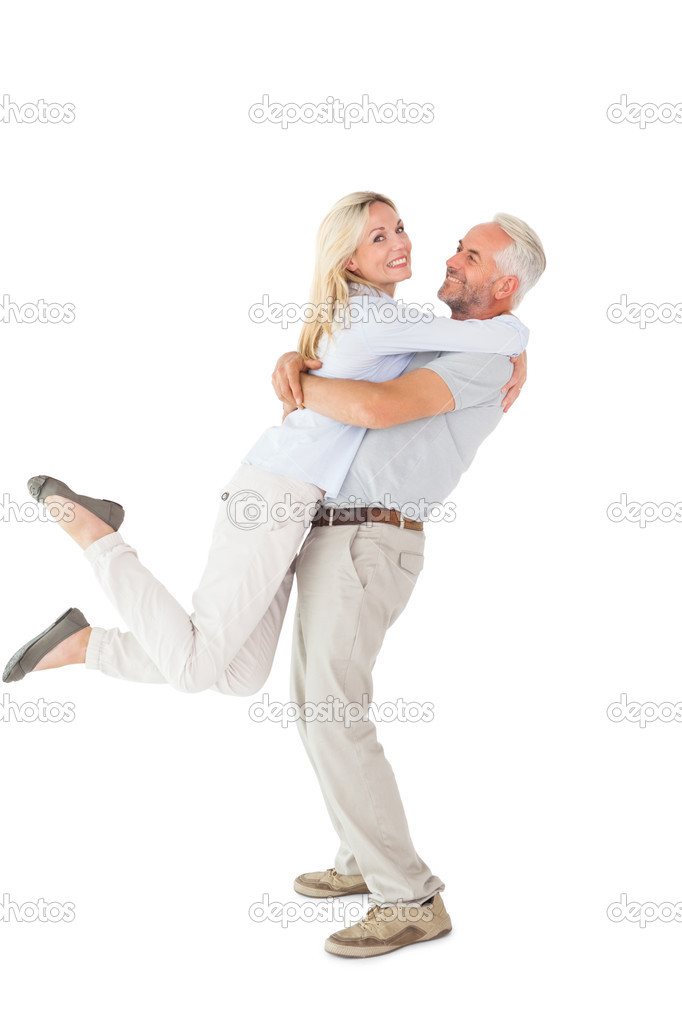 Man picking up his partner while hugging here Stock Photo by ...