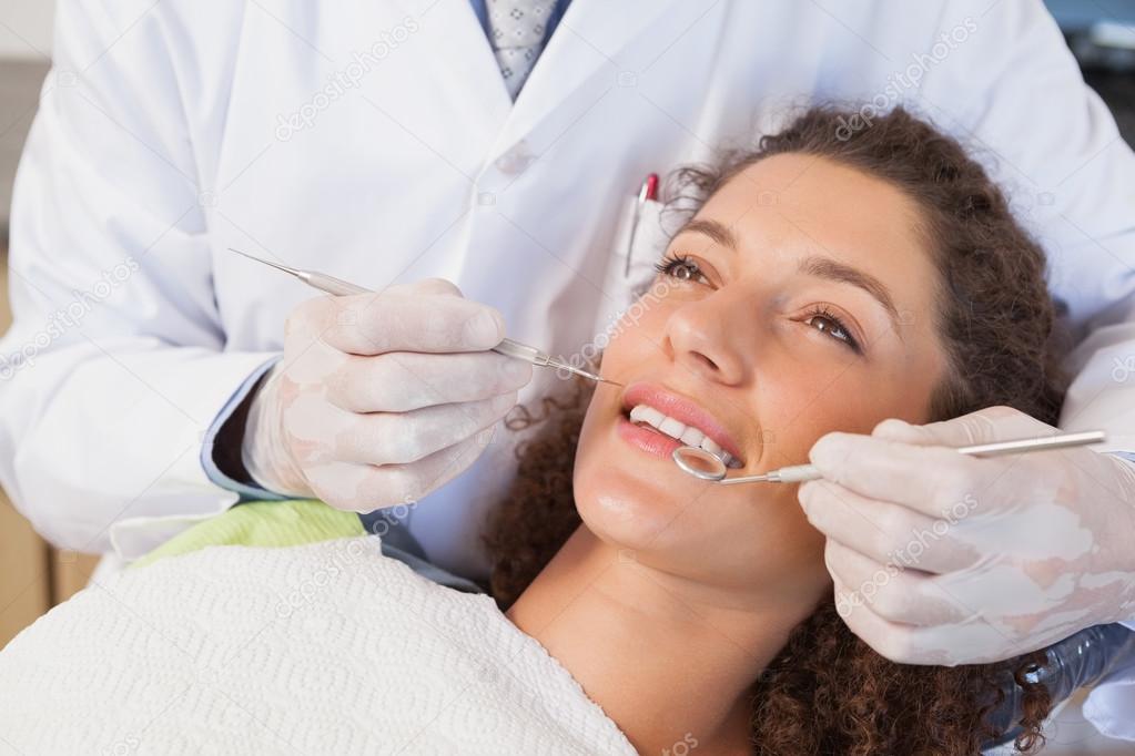 Dentist examining a patients teeth — Stock Photo © Wavebreakmedia #51601773