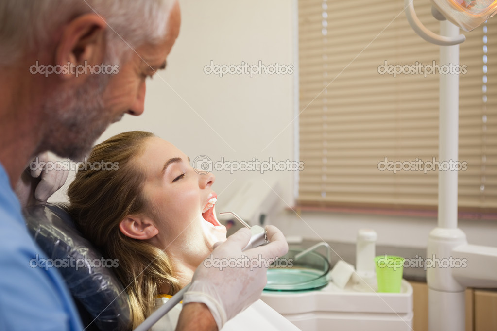 Dentist examining a patients teeth Stock Photo by ©Wavebreakmedia 51603541