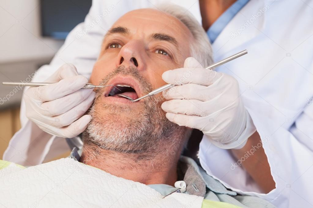 Dentist examining a patients teeth Stock Photo by ©Wavebreakmedia 51603673