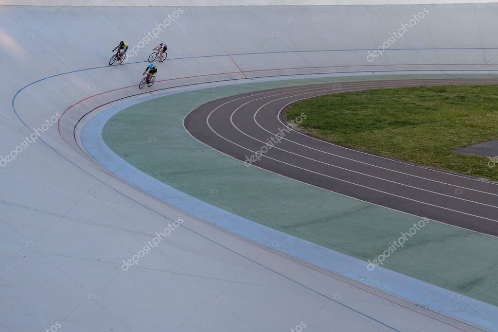 Three cyclists compete on a cycle track in a circle in Kyiv, Ukraine 2024