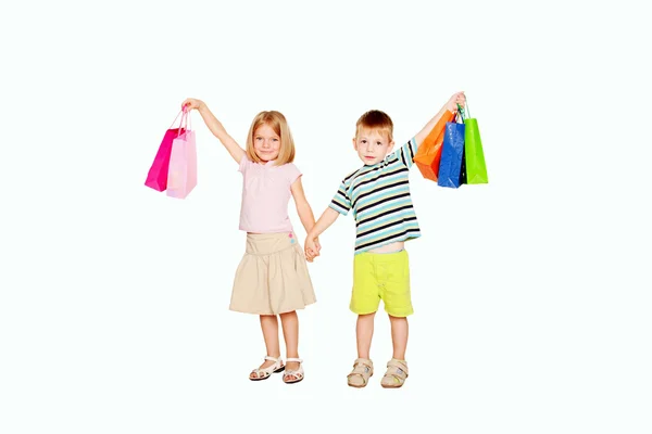 Kids shopping. Two little girls with their purchases and gifts. Stock ...