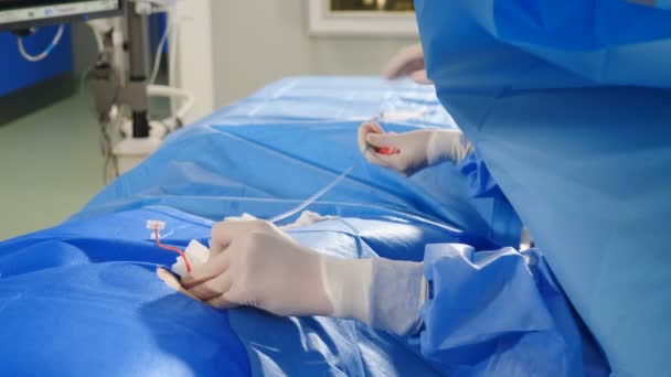 Vascular surgery. Hands of radiologist performing endovascular ...