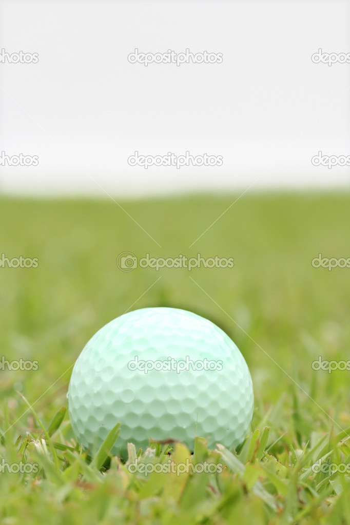 White Golf ball on green grass left side background — Stock Photo ...