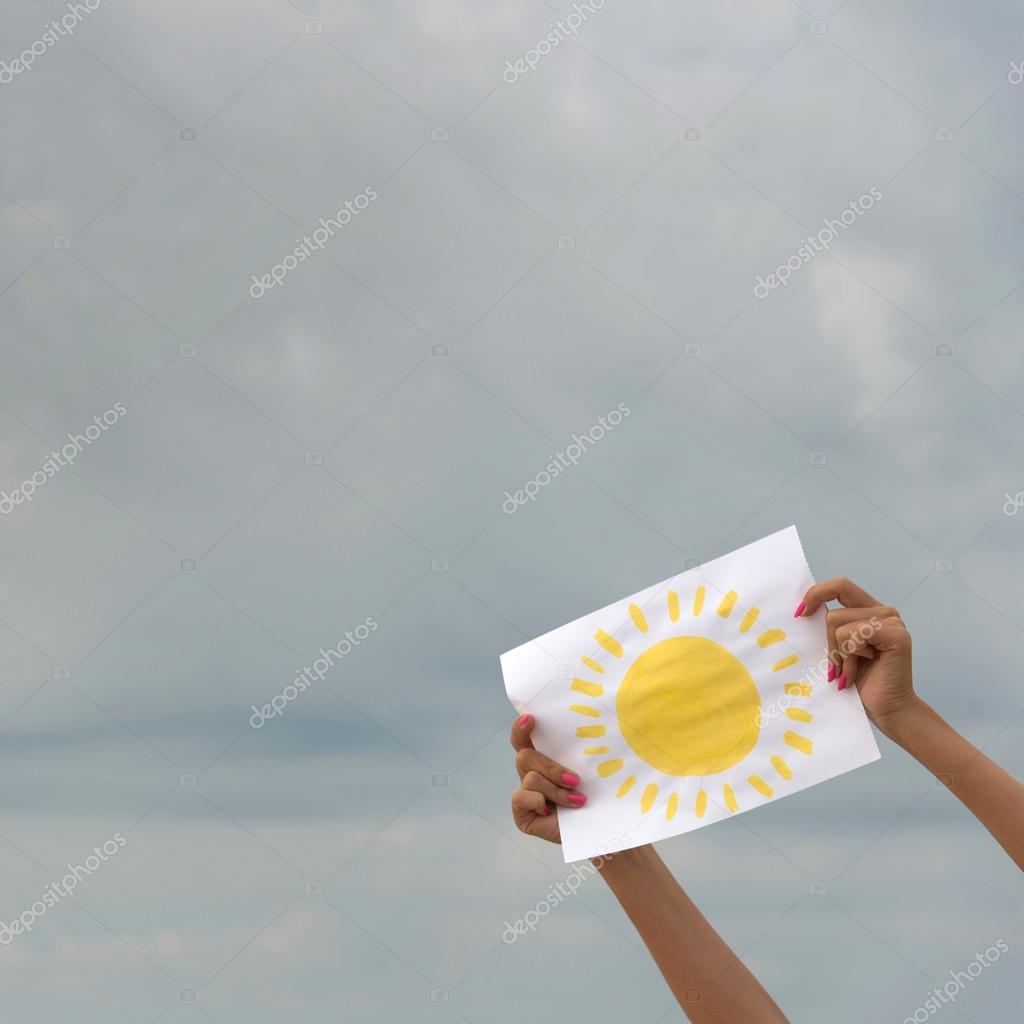 Sheet of paper with sun image against overcast sky — Stock Photo © EM ...