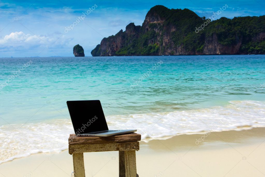 Computer notebook on beach Stock Photo by ©blacknote 12097099