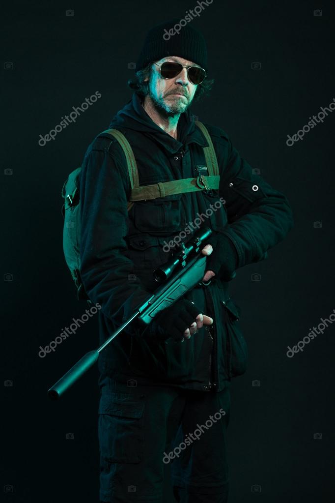 Download - Sniper with beard in black holding gun. Studio shot. — Stock ...