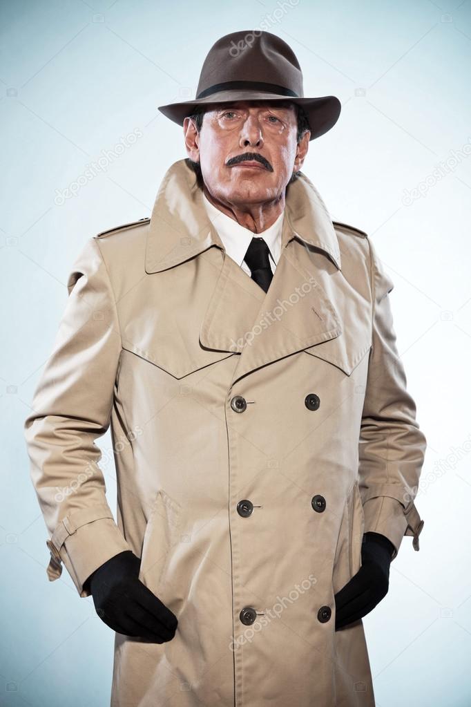 Retro detective man with mustache and hat. Wearing raincoat. Stu ...
