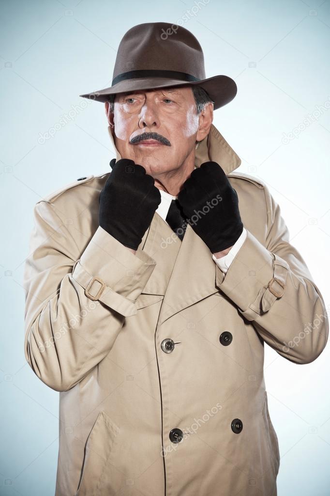 Vintage detective man with mustache and hat. Wearing raincoat. S Stock ...
