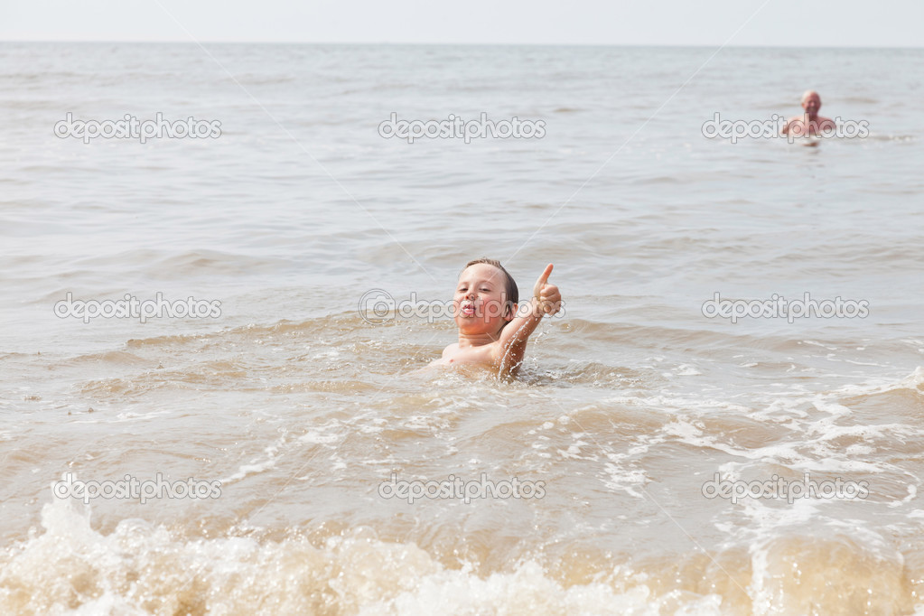 Young boy and grandpa swimming in the ocean. Enjoying the waves. — Stock Photo © ysbrand #28752071