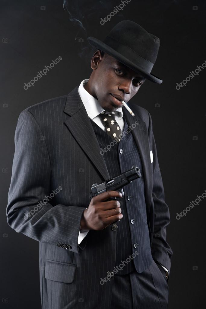 Retro african american mafia man wearing striped suit and tie an ...