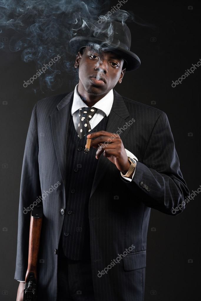 Retro african american mafia man wearing striped suit and tie an Stock ...
