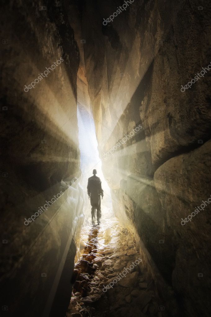 Man walking out of a cave Stock Photo by ©photocosma 43939691