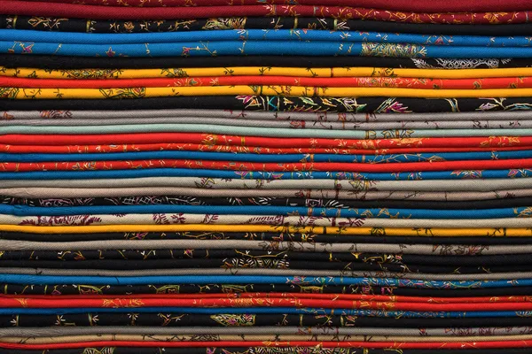 Heap of cloth fabrics at a local market in India Stock Photo by ...