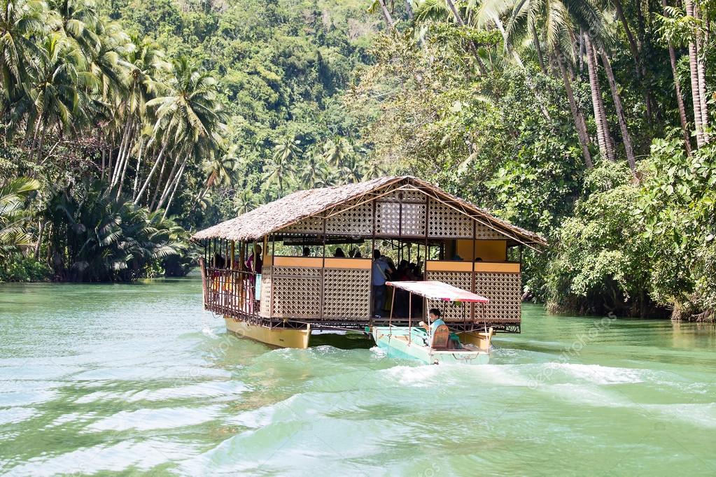 Exotic cruise boat with tourists on a jungle river. Island Bohol ...