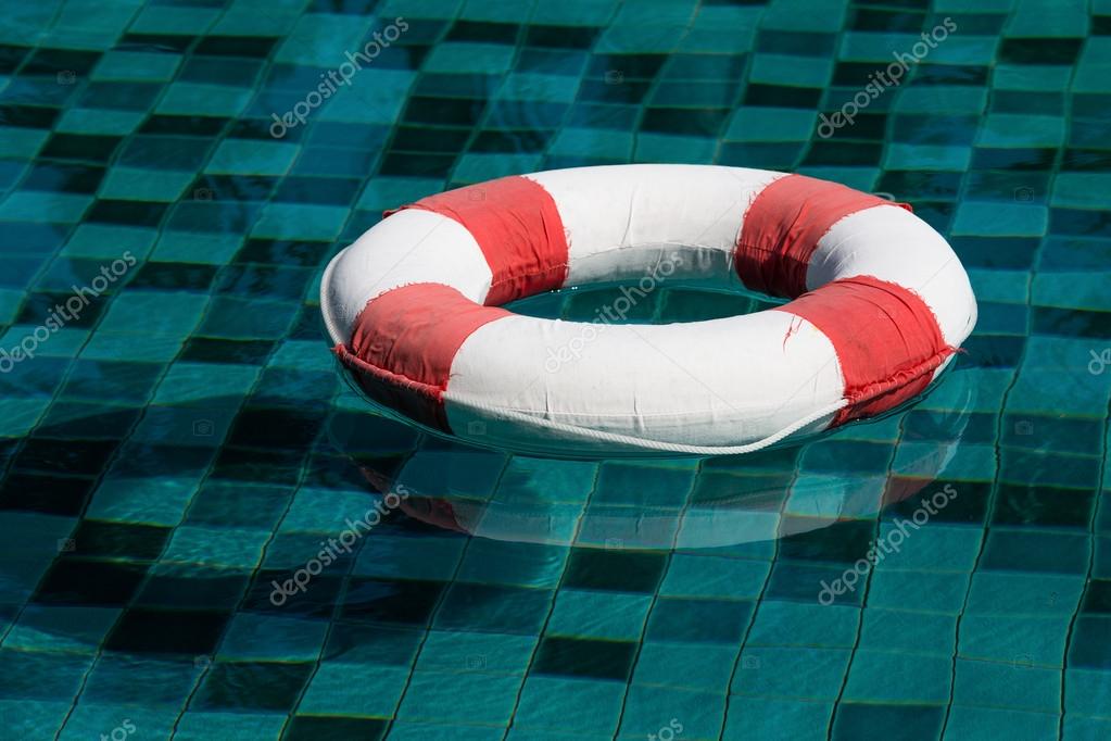 Life ring floating on top of sunny blue water — Stock Photo ...