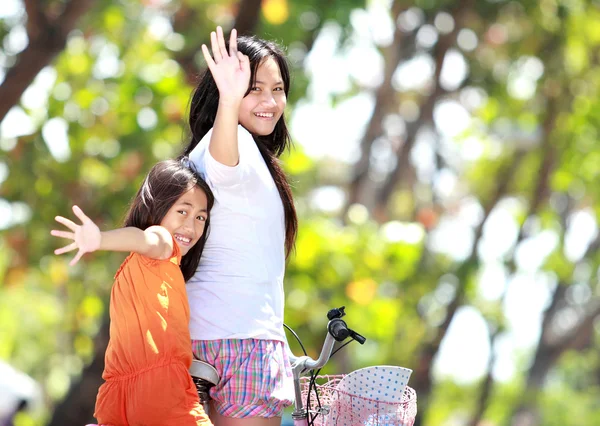 Two girls riding bicycle - Stock Image - Everypixel