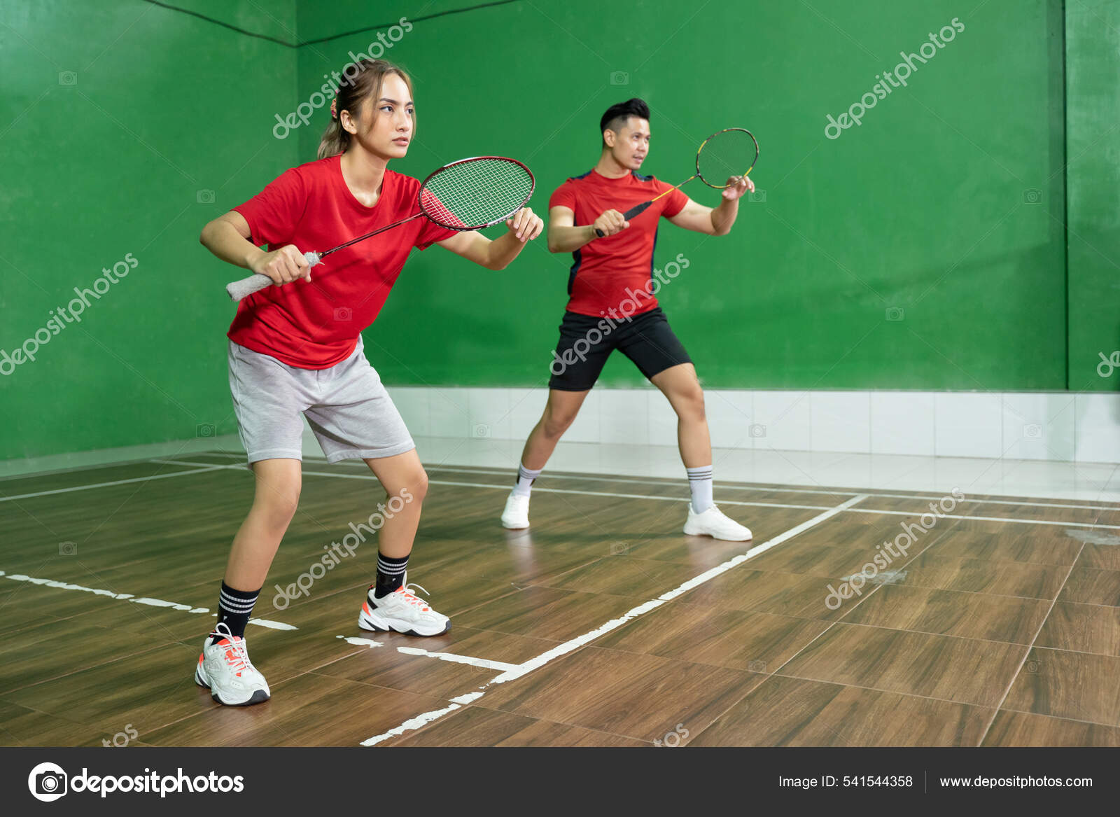 Mixed doubles badminton player with stance position ready to play ...