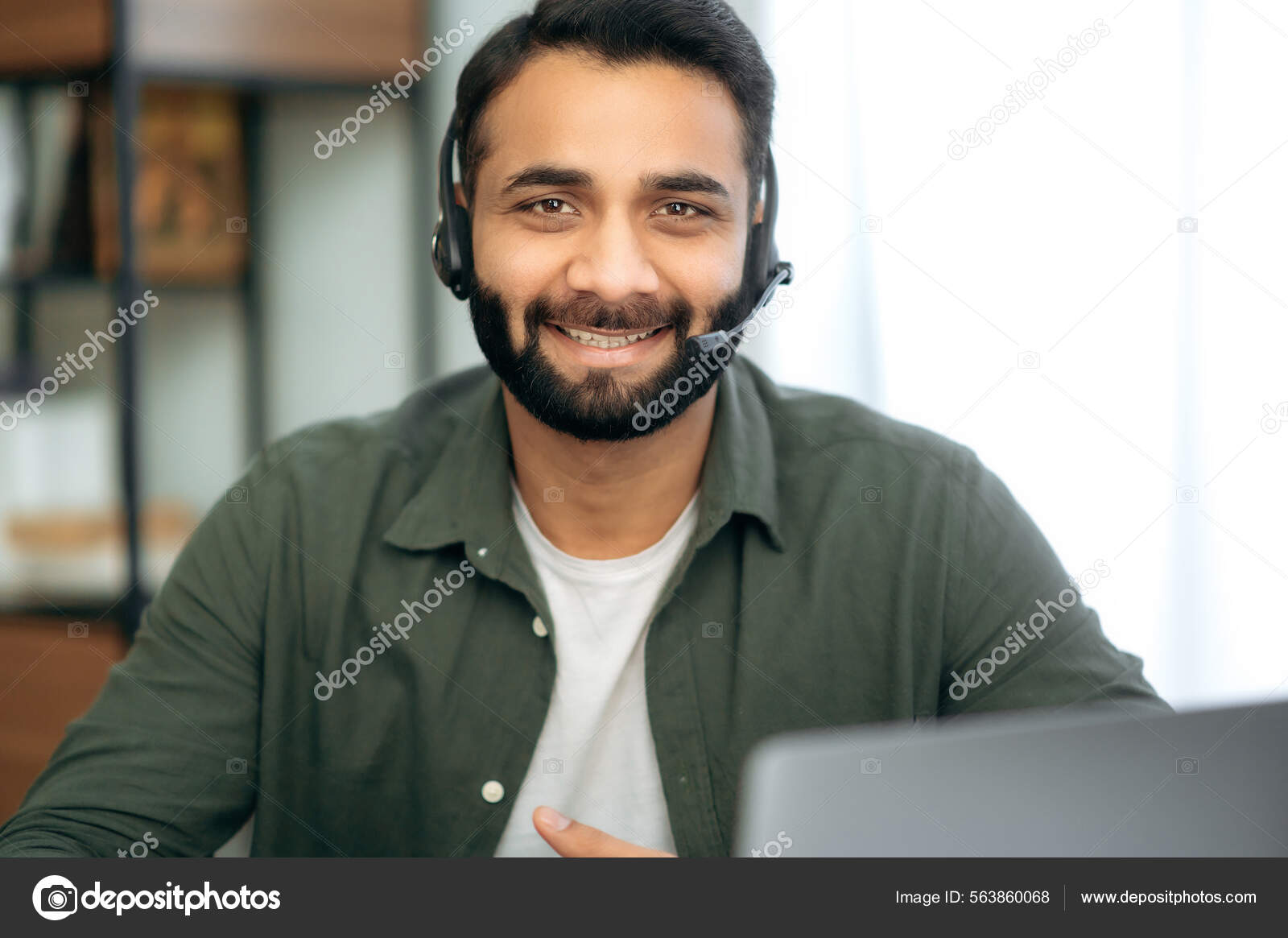 Friendly pleasant attractive Indian or Arabian man with headset ...