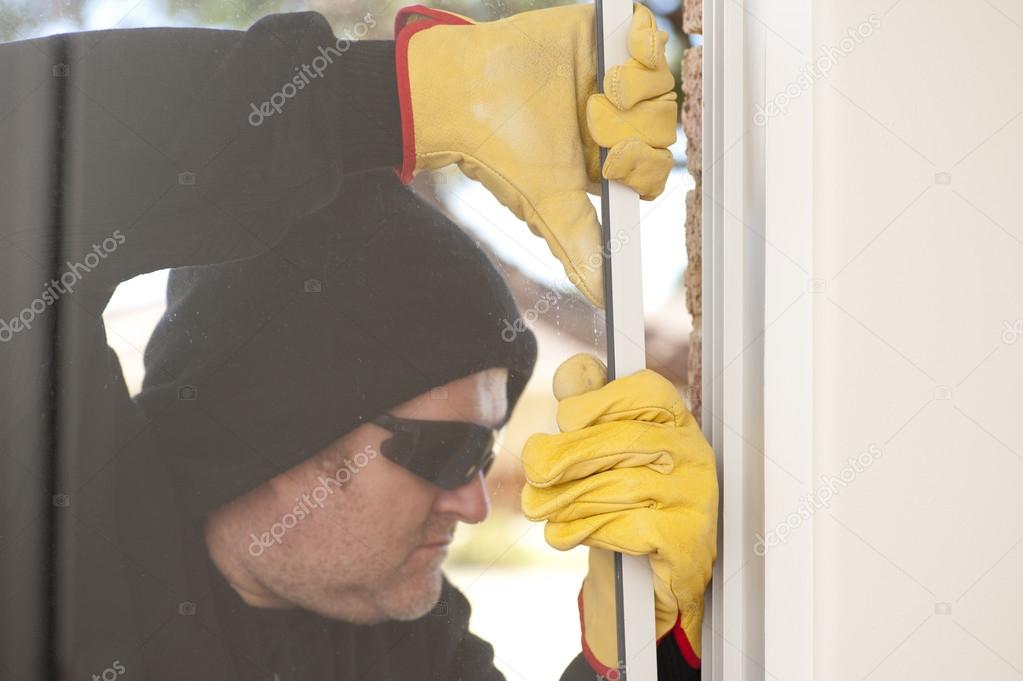 Burglar breaking through window of house Stock Photo by ©roboriginal ...