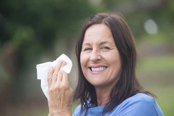 Smiling Woman with tissue outdoor - Stock Image - Everypixel