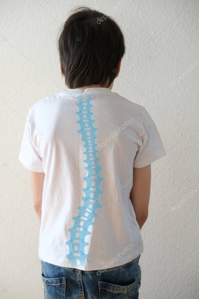 part of naked back of boy, child 10 years old in a white t-shirt bent ...