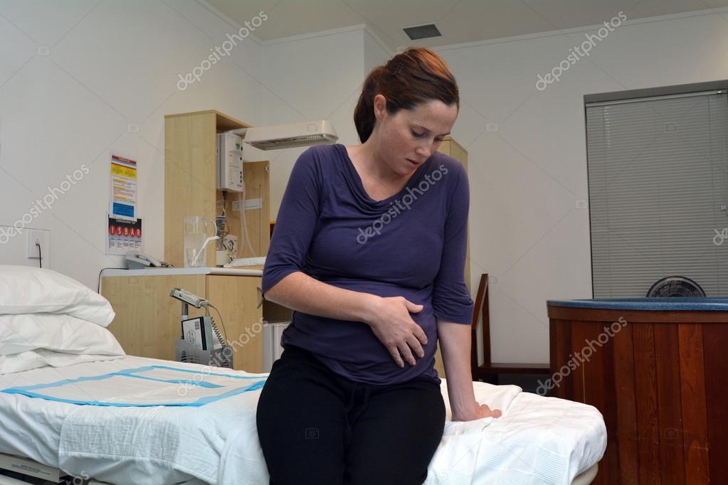Pregnant woman having contraction — Stock Photo © lucidwaters #48443493