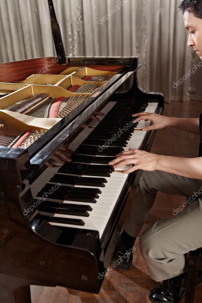Playing piano Stock Photo by ©OtnaYdur 24545657