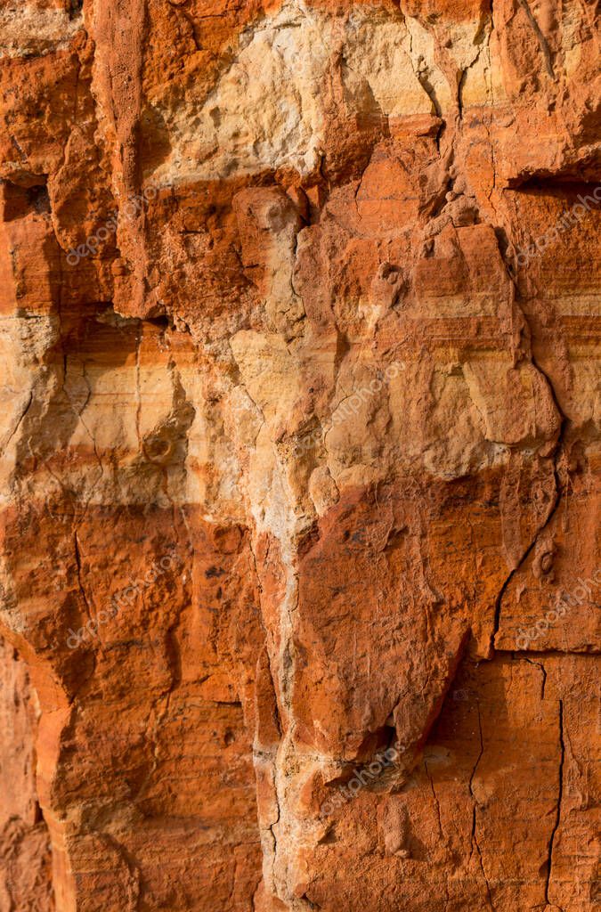 Sedimentary rocks with a high content of iron oxide. Red soil, loam. The texture of the soil. 2022