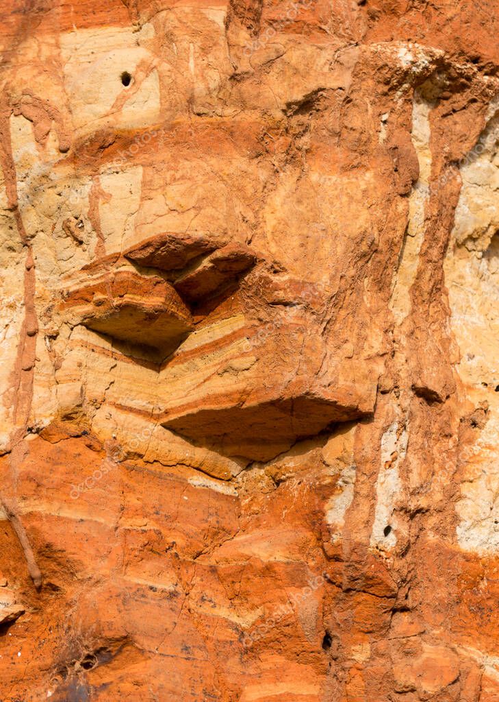 Sedimentary rocks with a high content of iron oxide. Red soil, loam ...