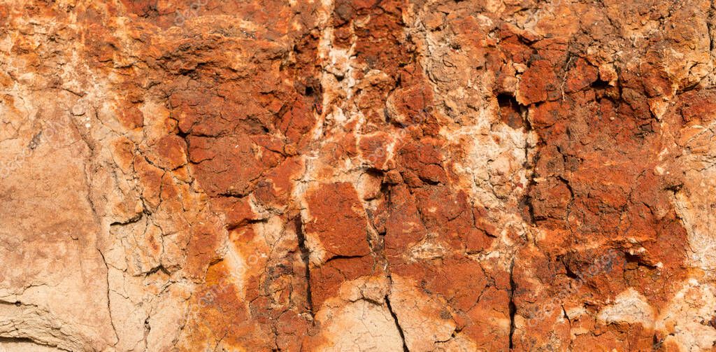 Sedimentary rocks with a high content of iron oxide. Red soil, loam ...