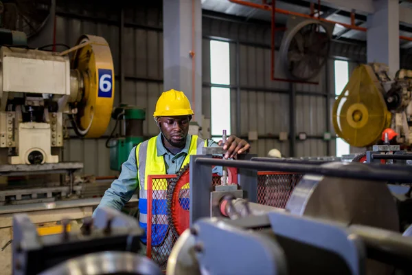 Foreman or worker work at factory site check up machine or products in ...