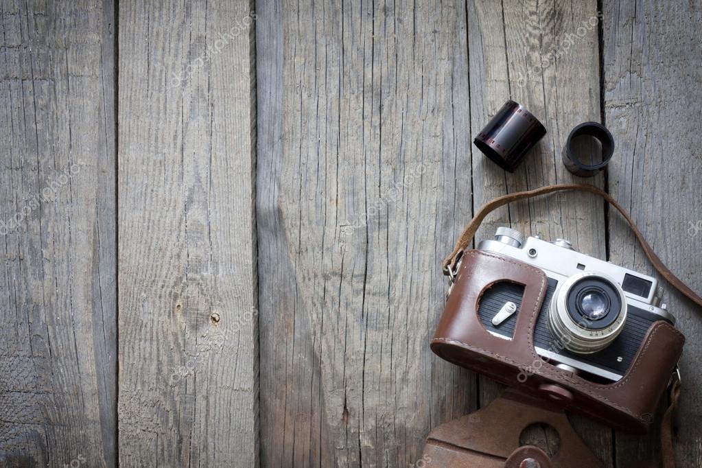Old retro camera on vintage wooden boards abstract background — Stock ...