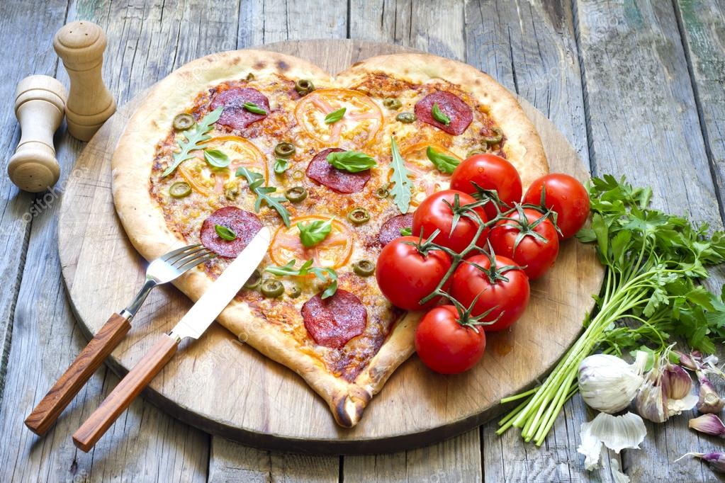 Pizza heart shape with cheese and tomato on vintage boards Stock Photo ...