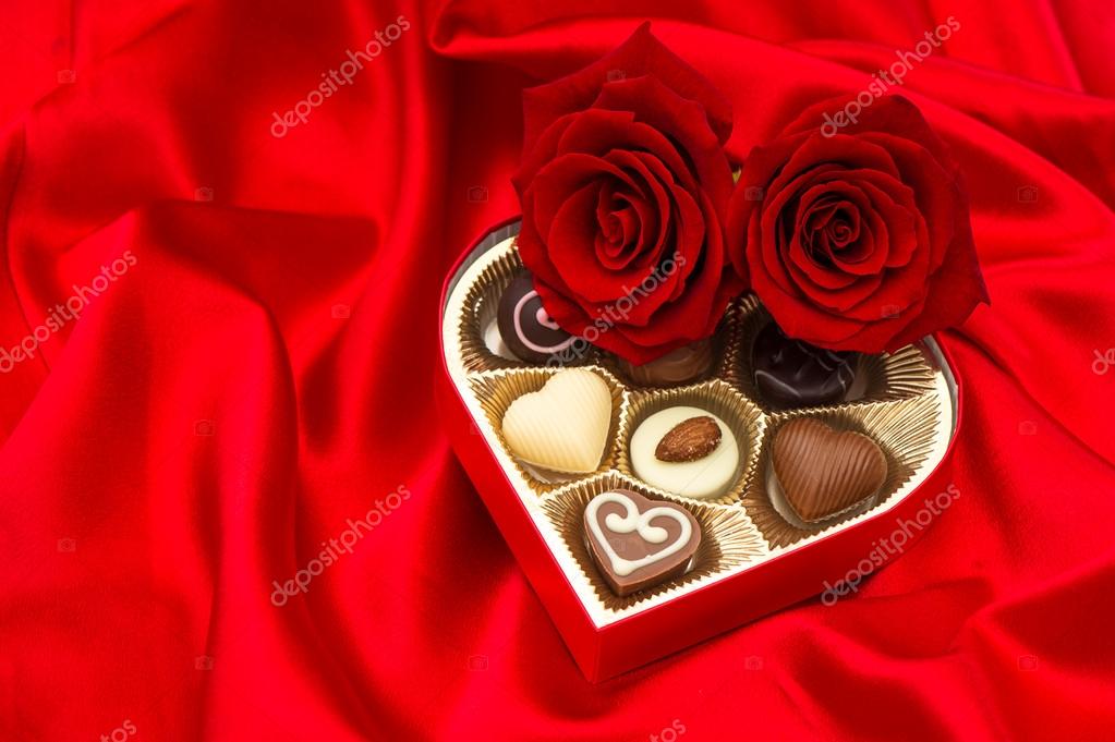 Red roses and assorted chocolate pralines in gift box Stock Photo by ...