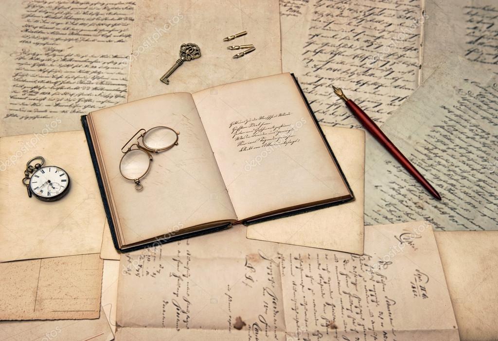 Antique writing accessories, open diary book, old letters and po Stock ...