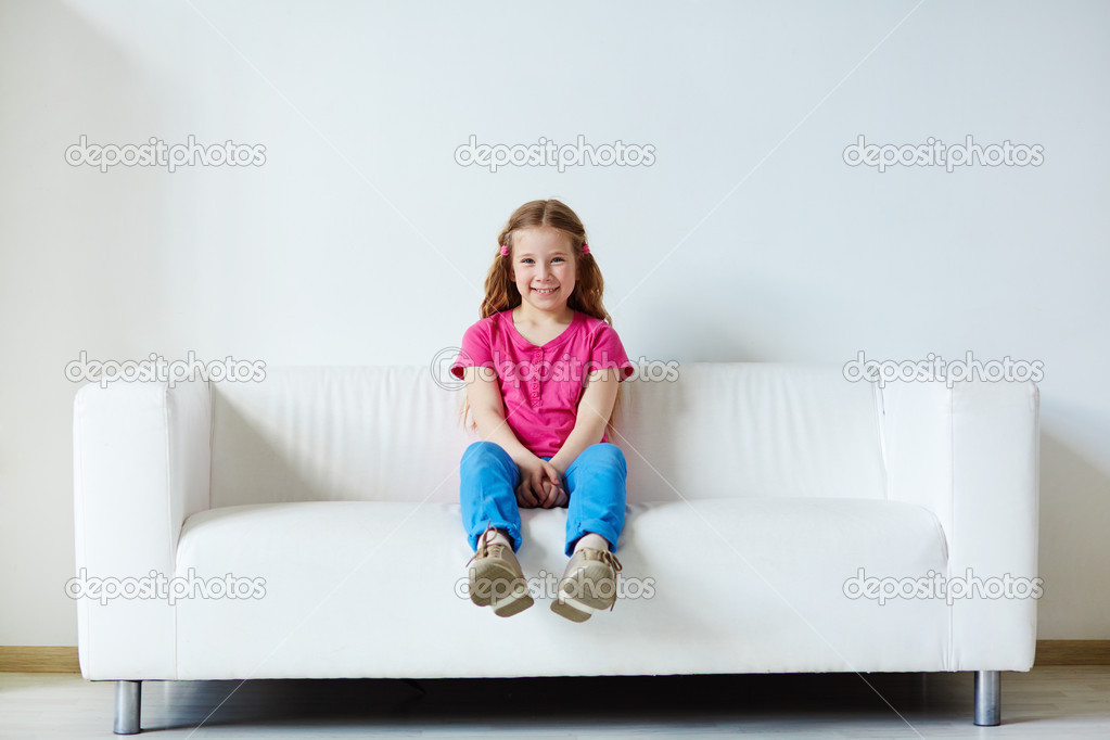 Girl on sofa Stock Photo by ©pressmaster 46321707