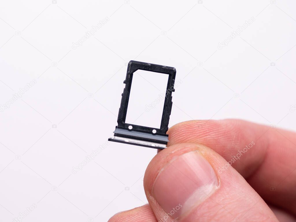 SIM tray for SIM card in smartphone close-up view on a white background ...