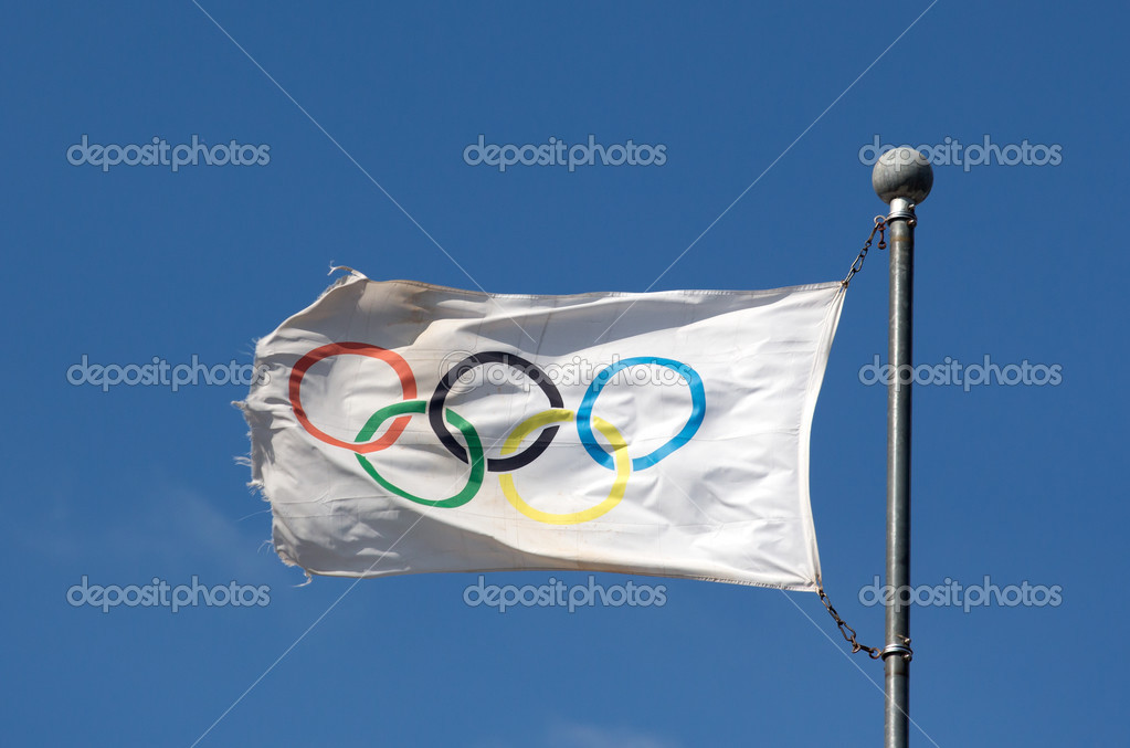 Olympic flag against a blue sky in sunlight — Stock Editorial Photo ...